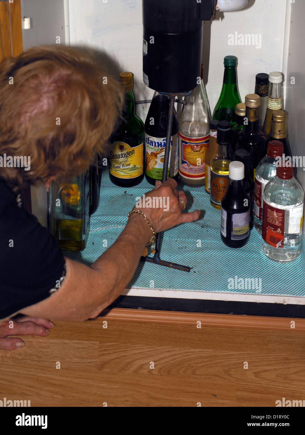 Person Using De-Jamming Tool on Waste Disposal Unit Stock Photo - Alamy