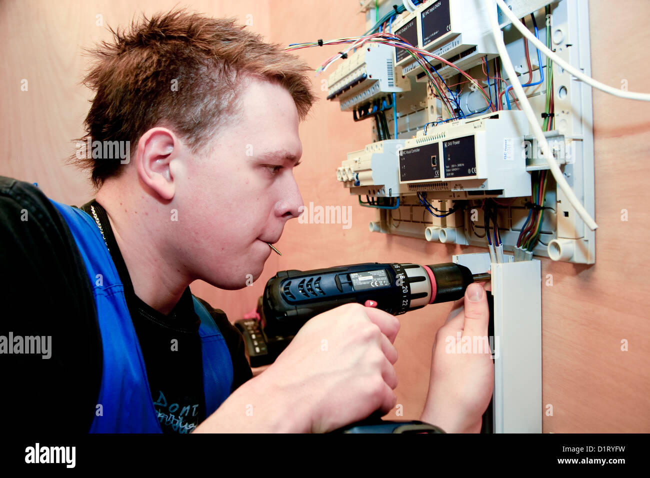 Young electrician installing an electricity system Stock Photo - Alamy