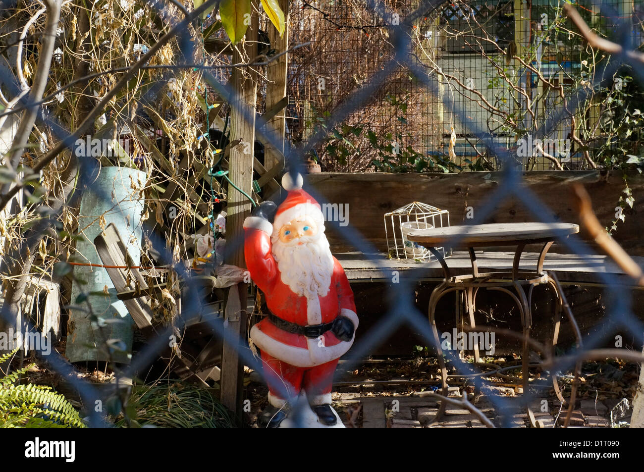 Plastic santa and junk in trashy backyard Stock Photo - Alamy