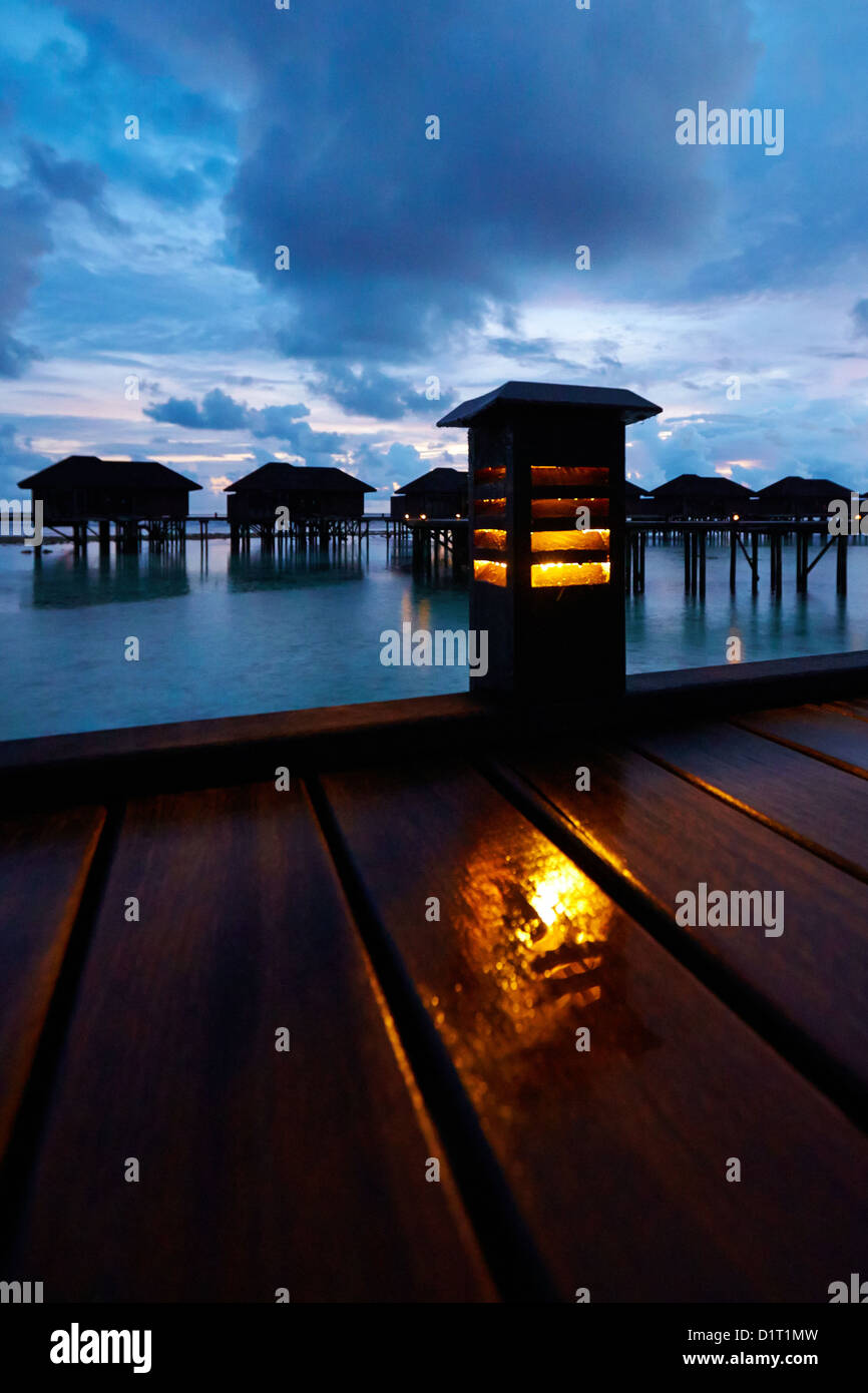 Light on raised walkway at night in the Maldives Stock Photo - Alamy