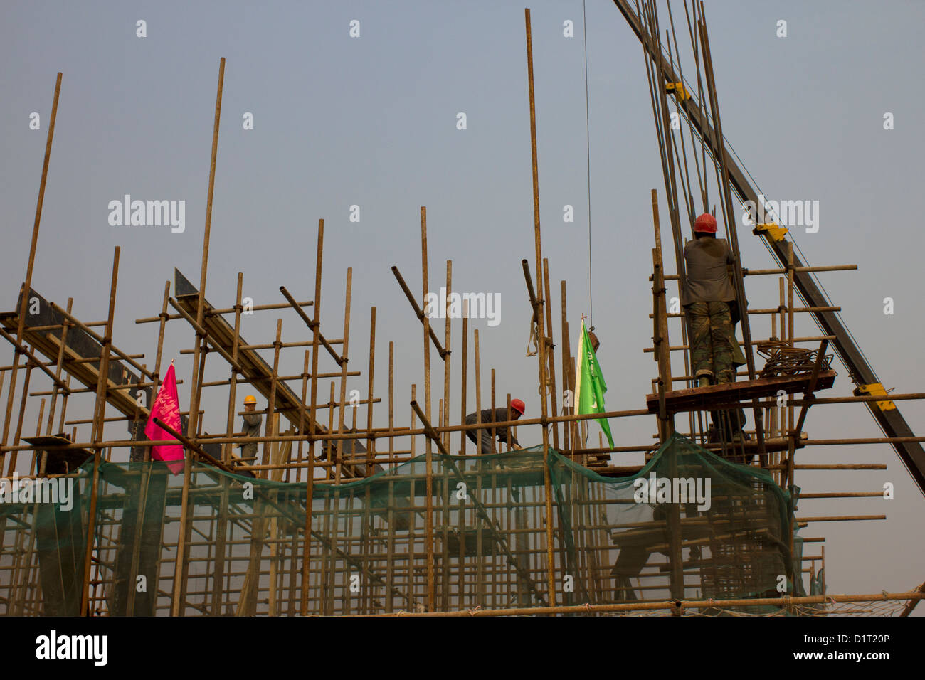 Chinese workers on scaffolding during construction of Huinanzhuang ...