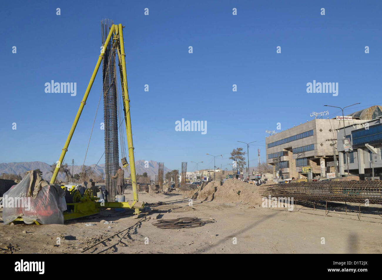 Laborer busy in work as the construction work of flyover is in progress ...