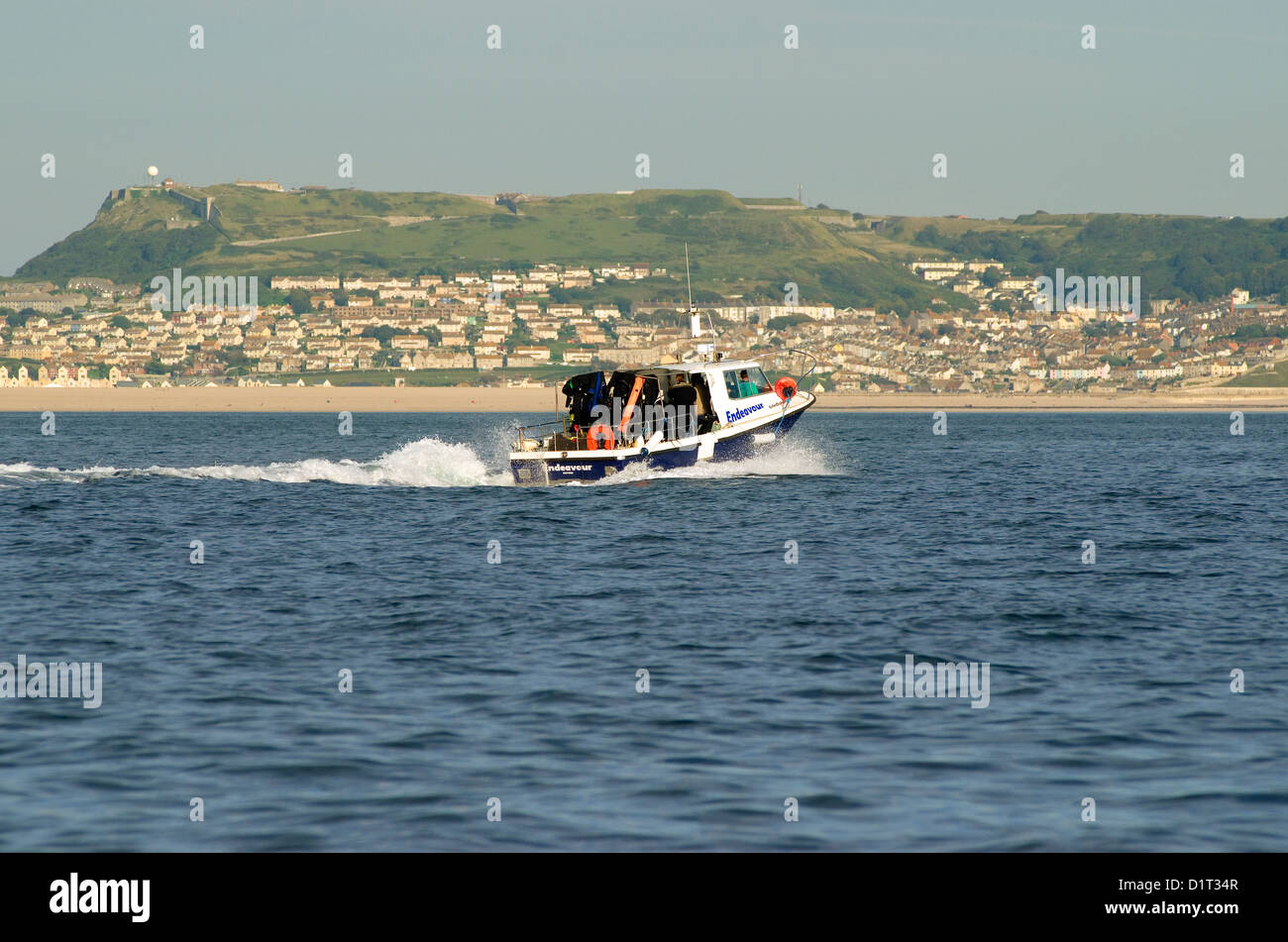A dive boat passes Chesil Cove and Chiswell, Portland, before rounding ...