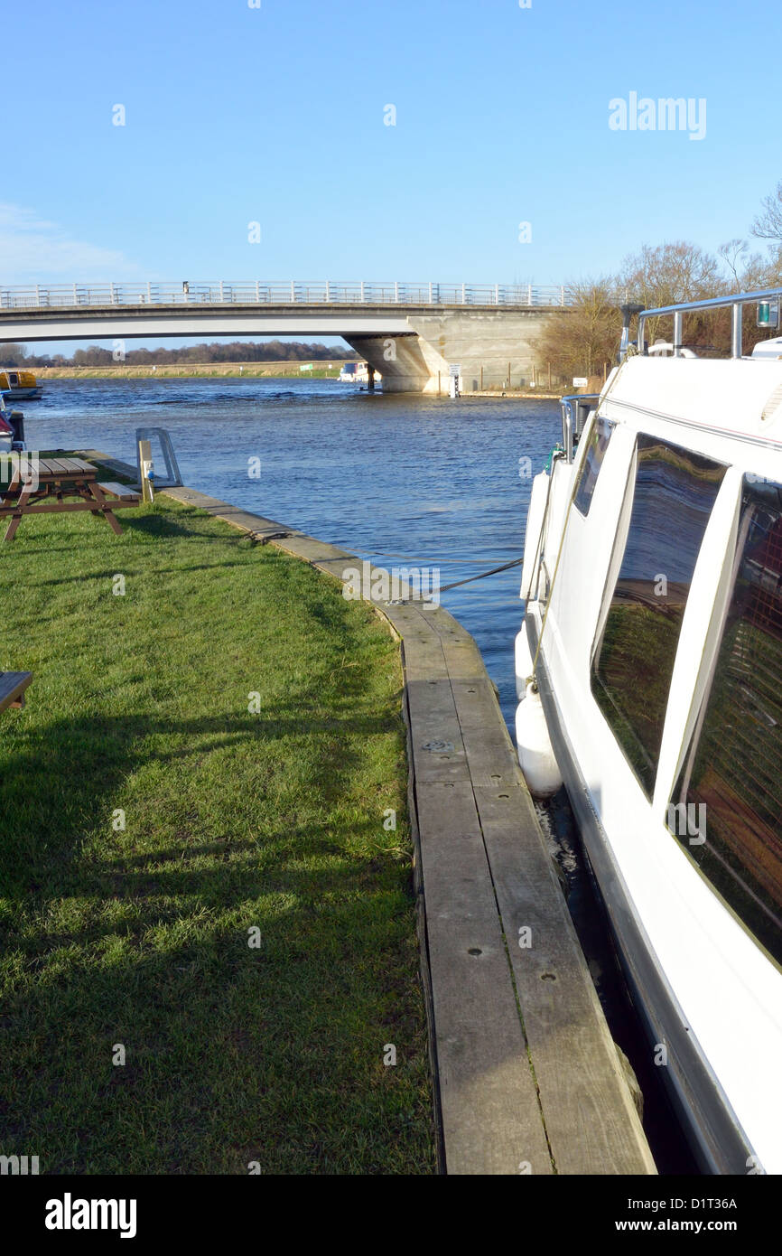 Broads cruiser moored at the Acle Bridge Inn on the River Bure near ...
