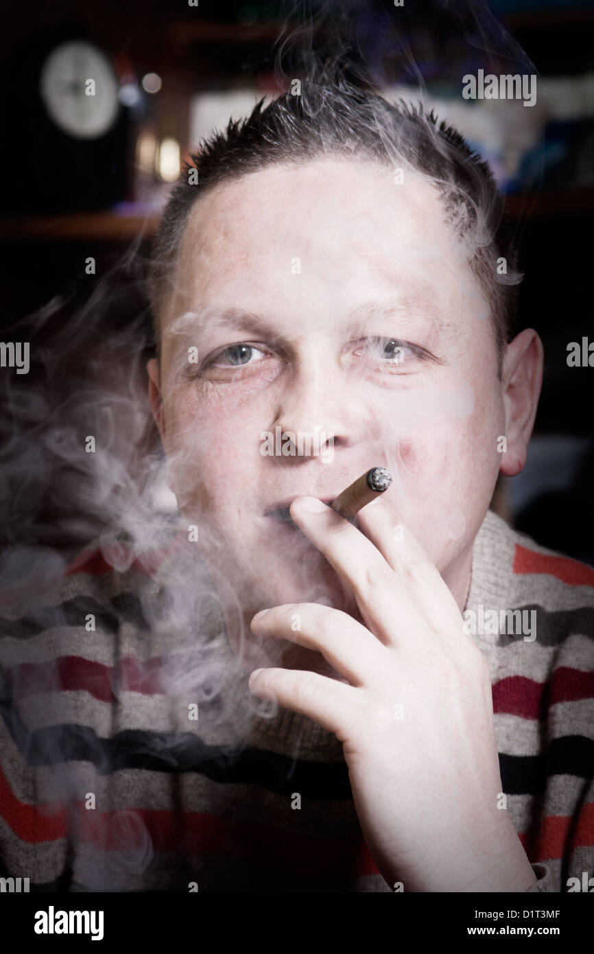 Close up portrait of man smoking cigar Stock Photo - Alamy
