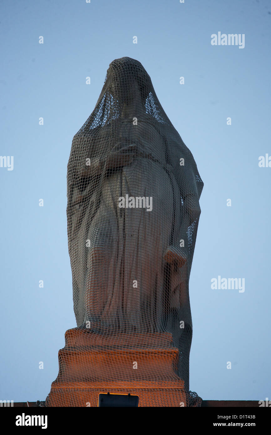 Covered statue on city building Stock Photo - Alamy