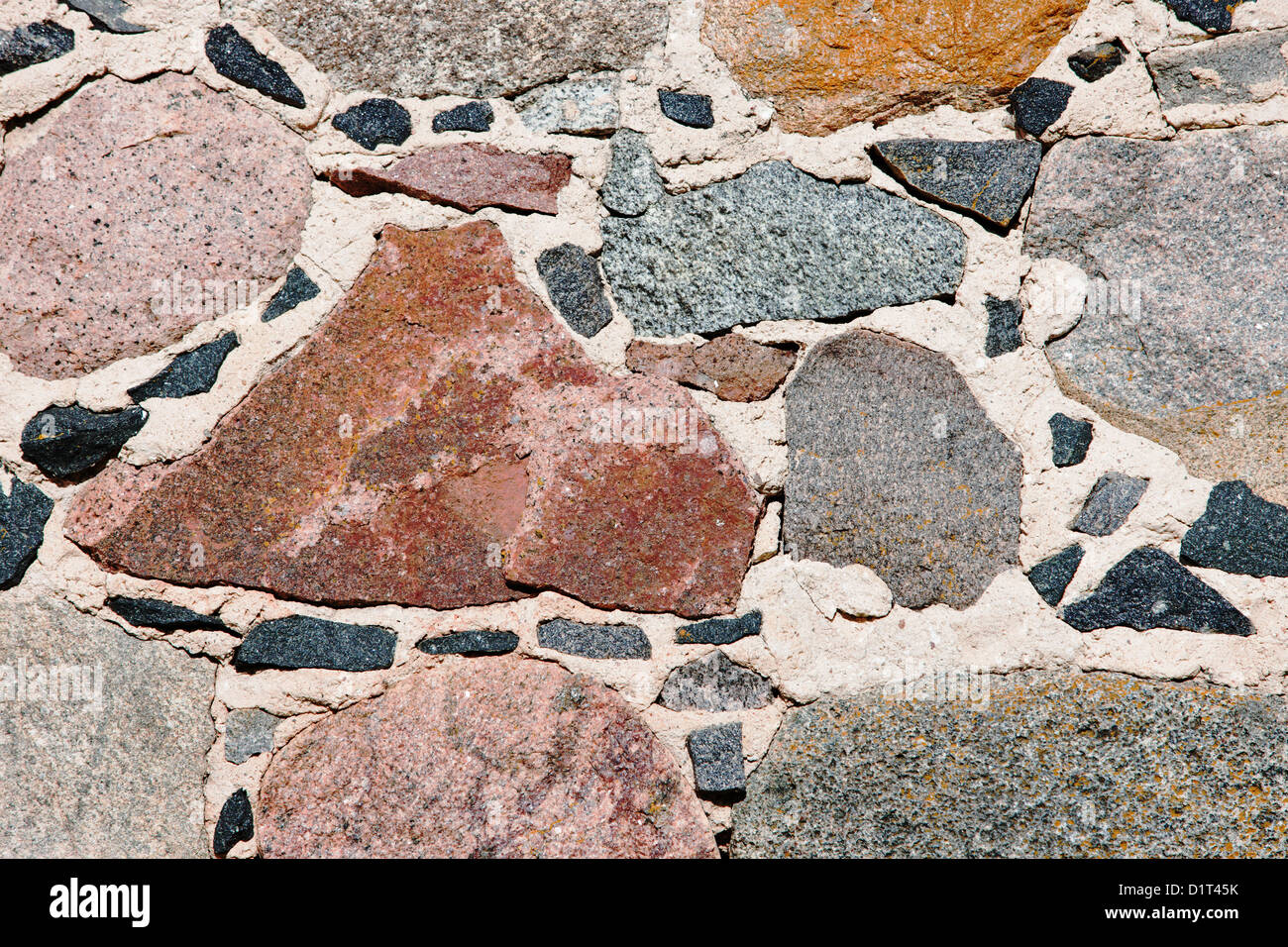 Fragment of an old handmade stone wall with colorful stones Stock Photo ...