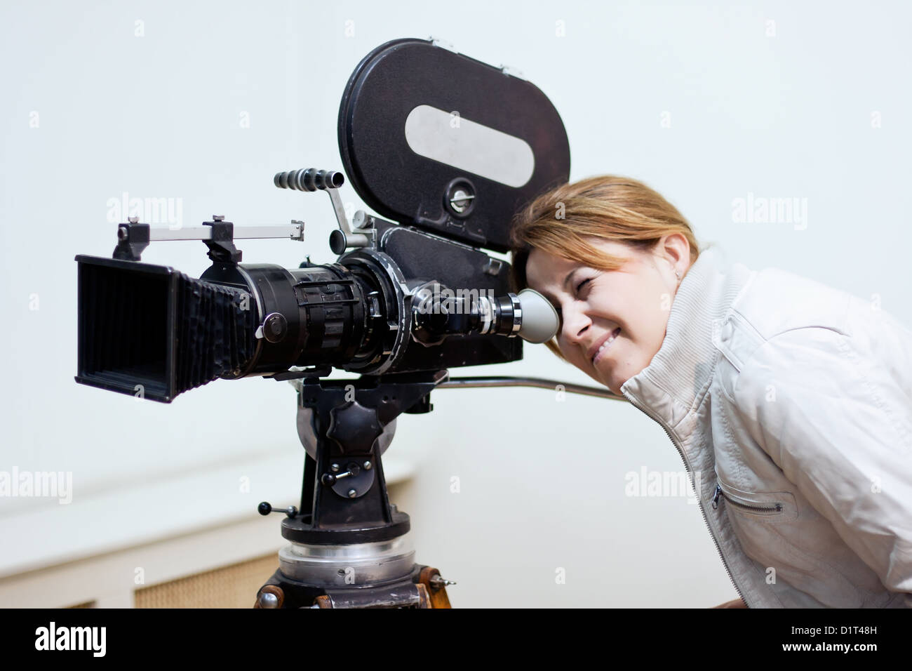 Women looking through old movie camera Stock Photo - Alamy