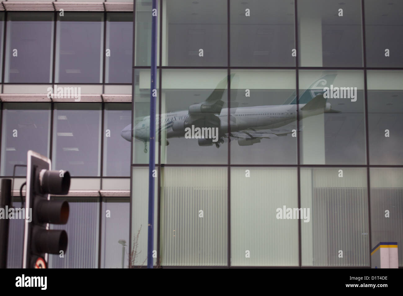 Reflection of an airplane in office windows Stock Photo - Alamy