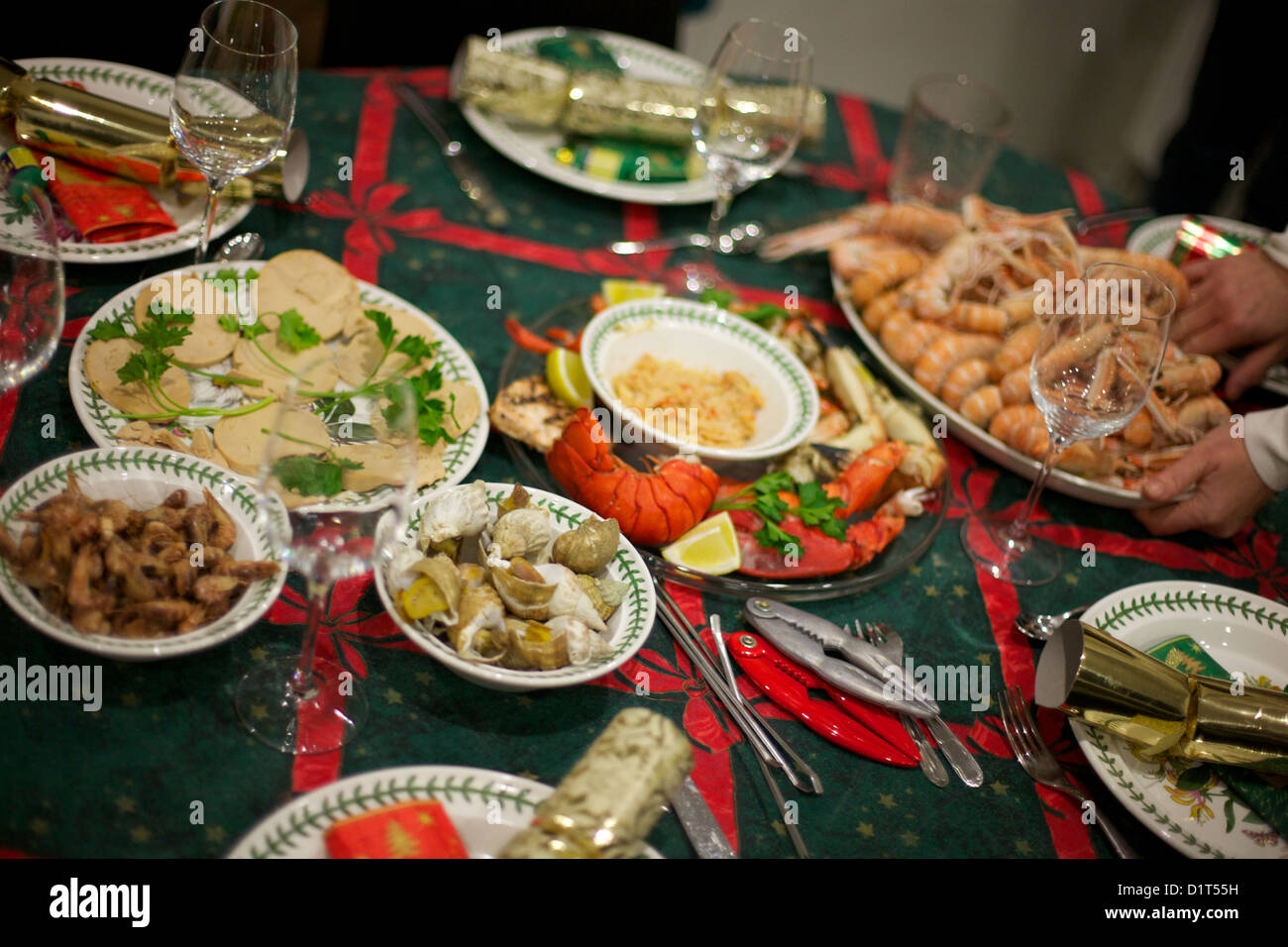 Christmas lunch table with Foie Gras, langoustine, crackers, whelks ...