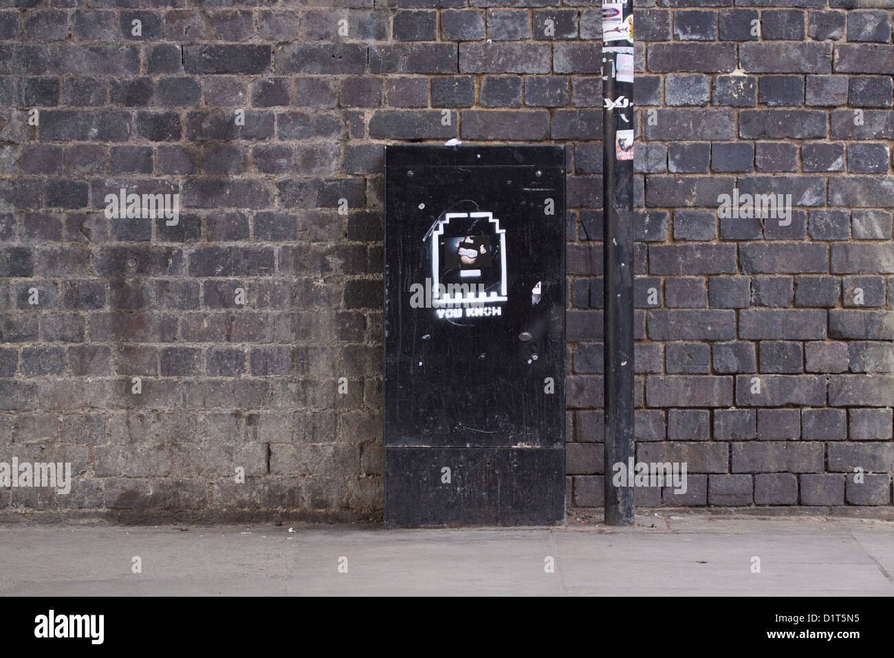 bt box with graffiti and poster with the writing "you know" and brick ...