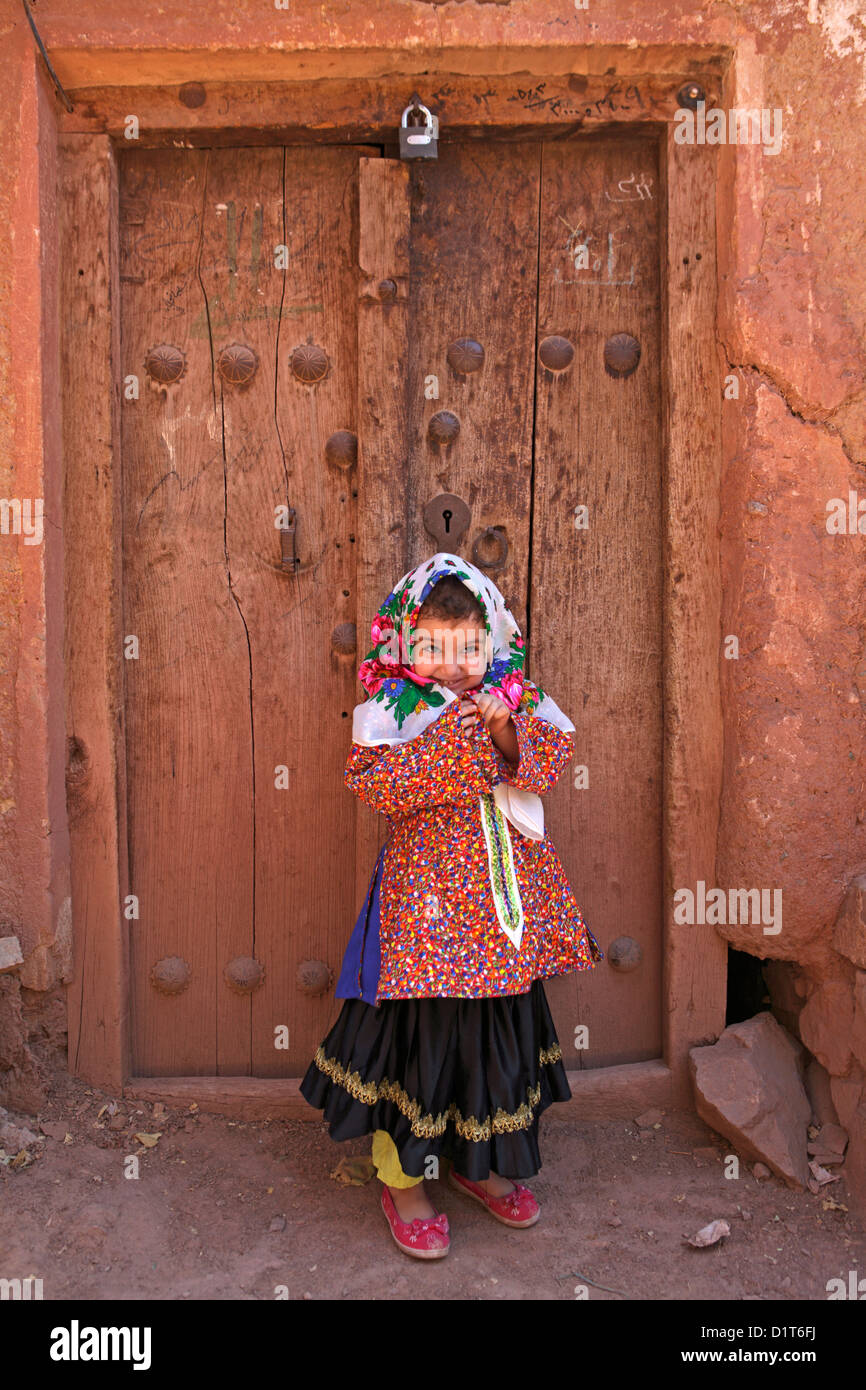 Portrait of iranian little girl wearing the traditional floreal chador ...