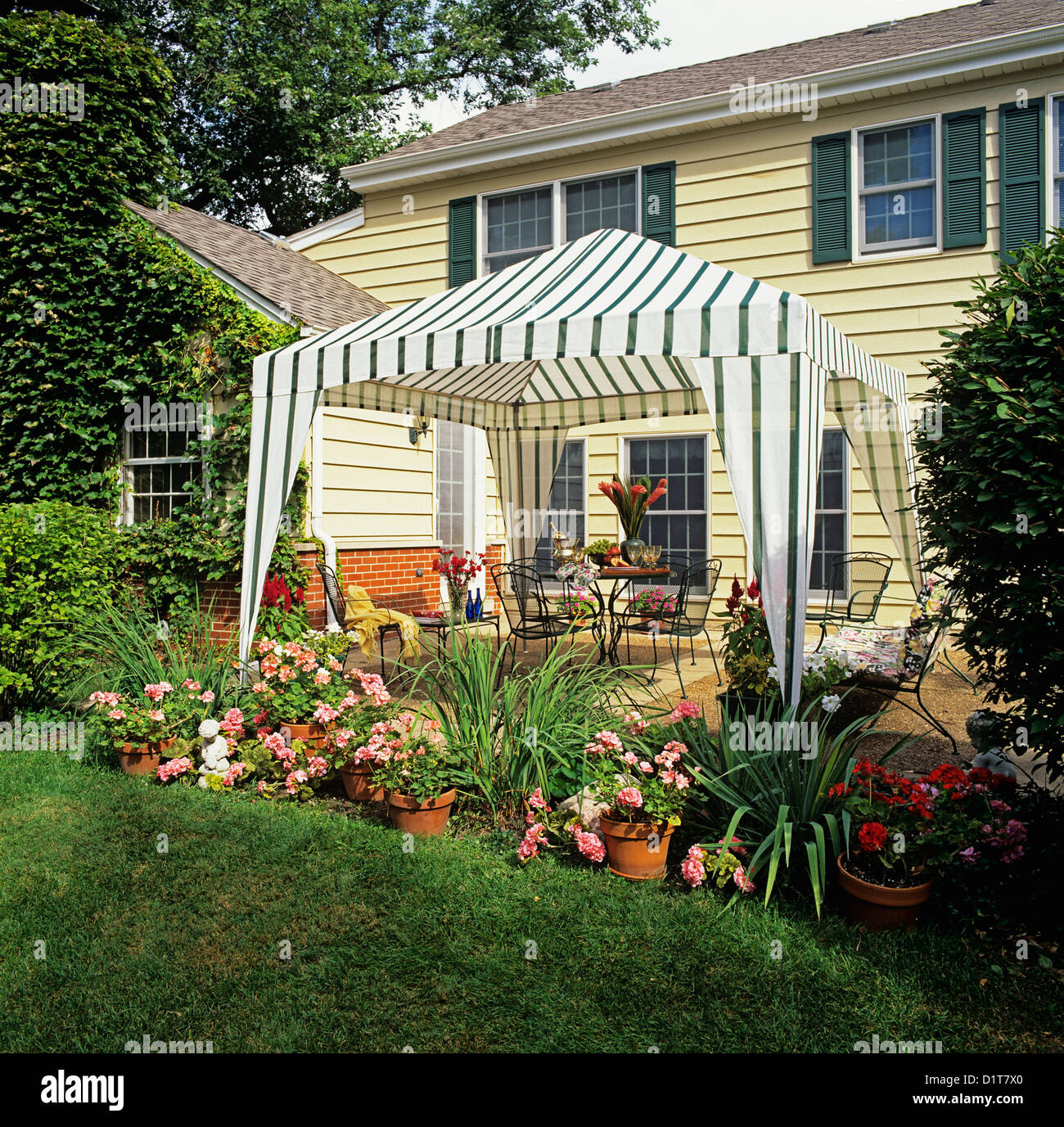 Patio. View towards house. Gazebo tent. Table set Stock Photo - Alamy