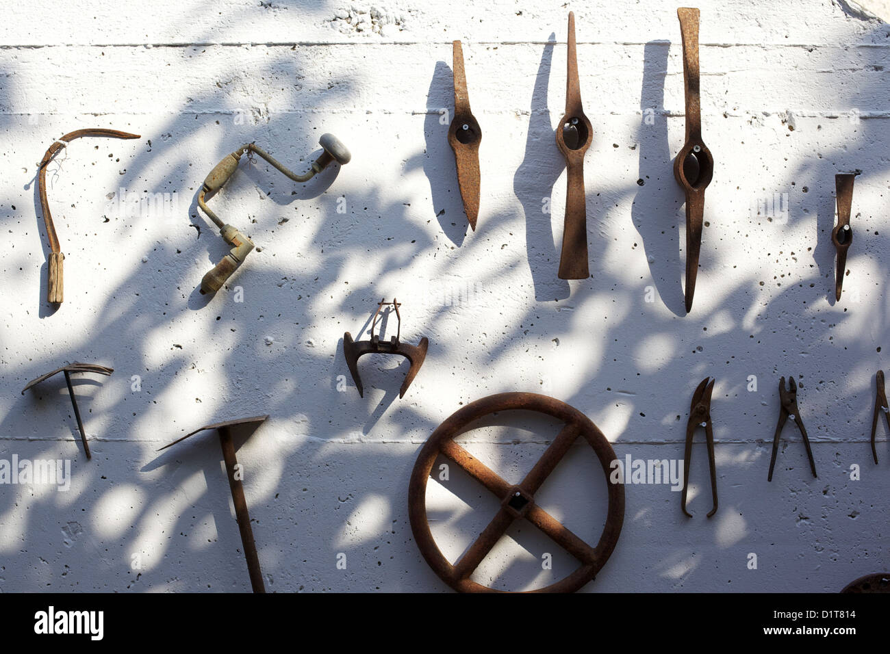 Old, rusting, farm tools hanging on a wall Stock Photo - Alamy