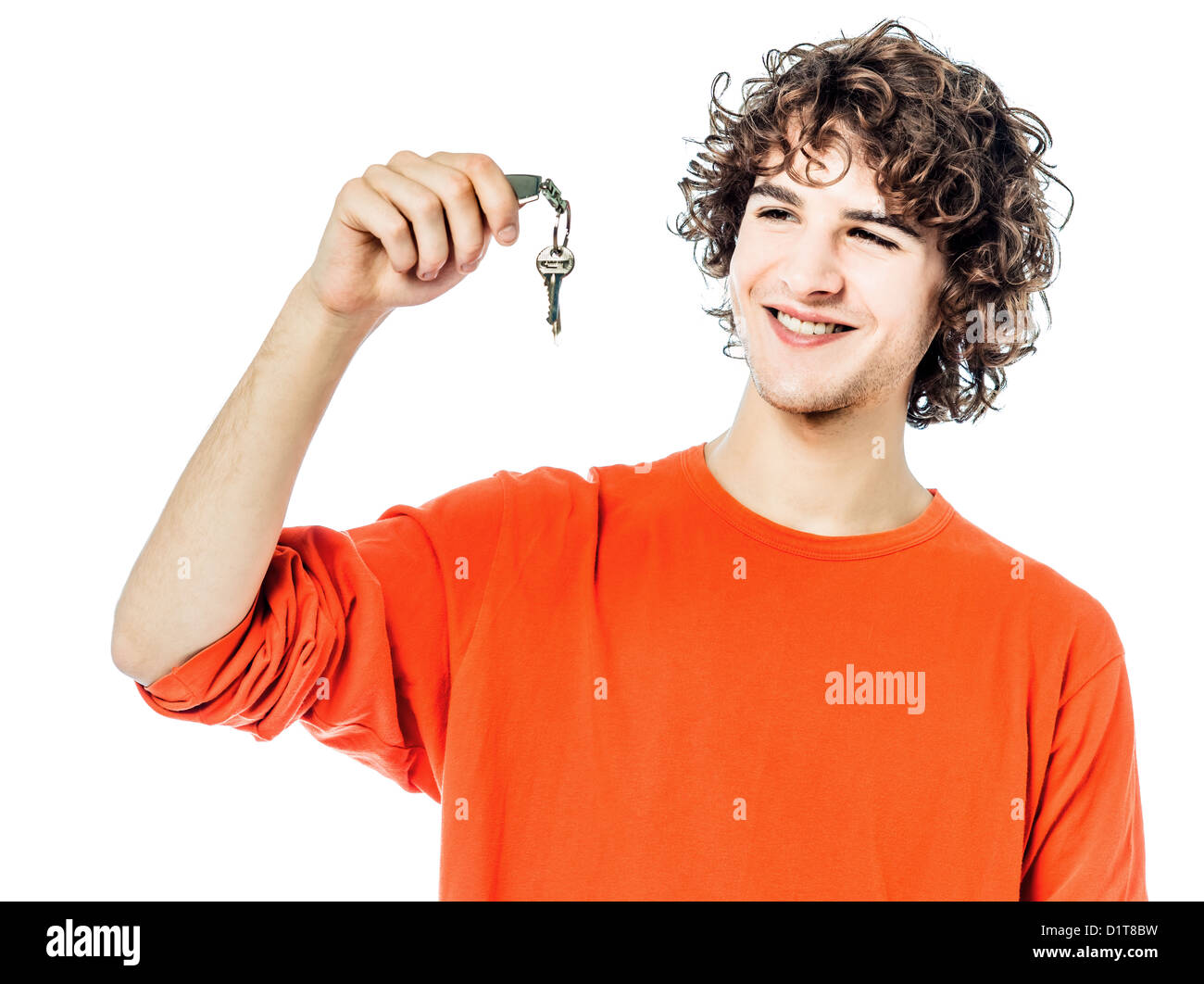 one young man holding keys portrait in studio white background Stock ...