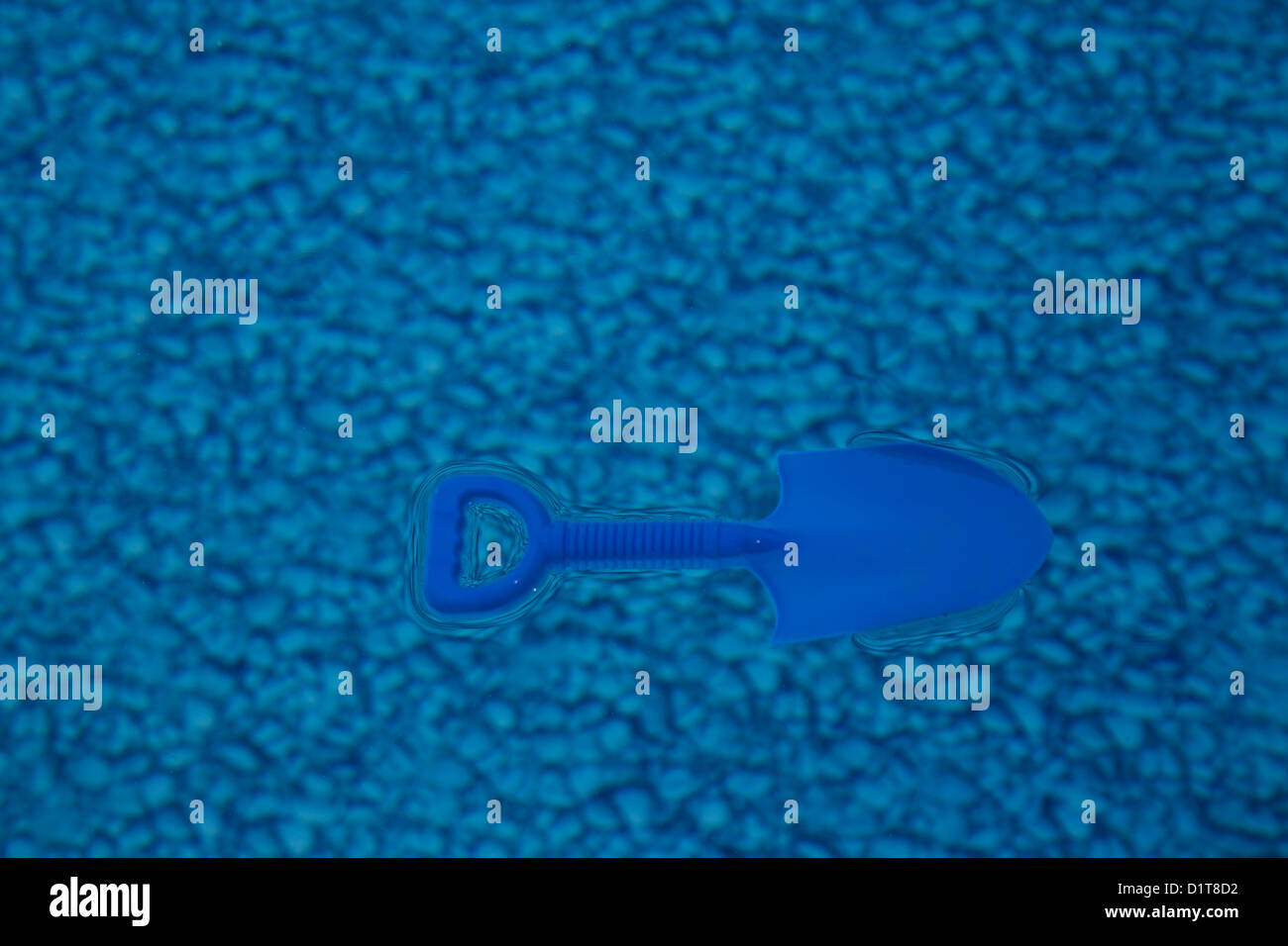 blue plastic spade floating in a swimming pool Stock Photo - Alamy