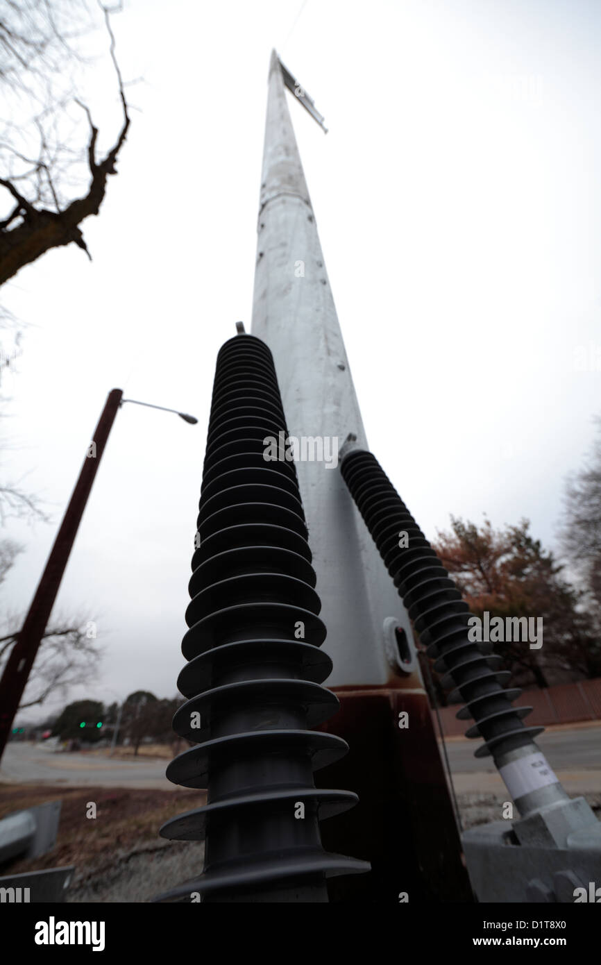 Large insulators leaning against new steel power pole Stock Photo - Alamy