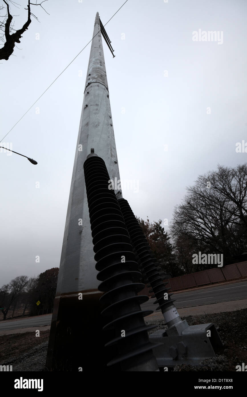 Large insulators leaning against new power pole Stock Photo - Alamy