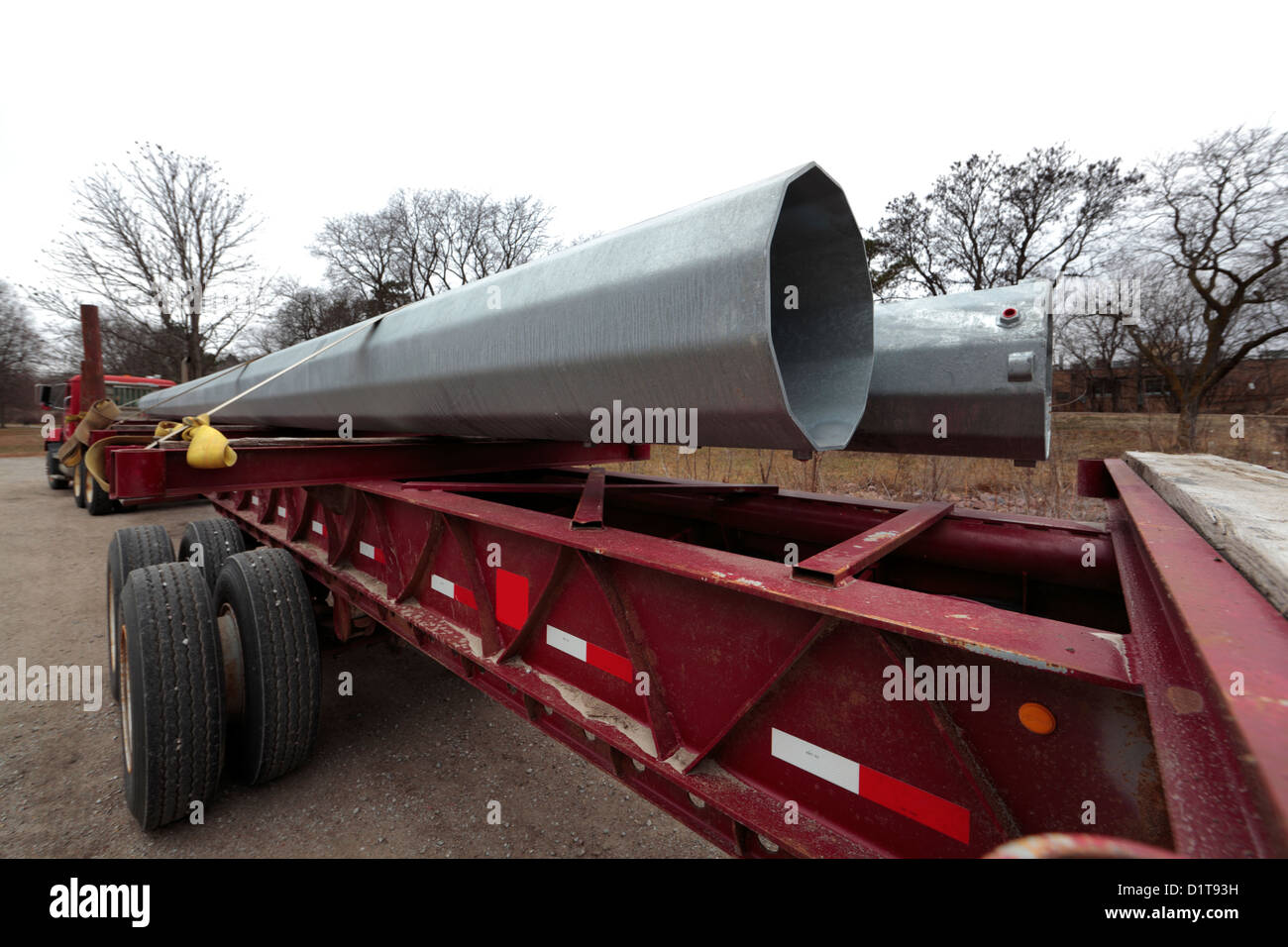 Steel power poles on flatbed trailer Stock Photo - Alamy