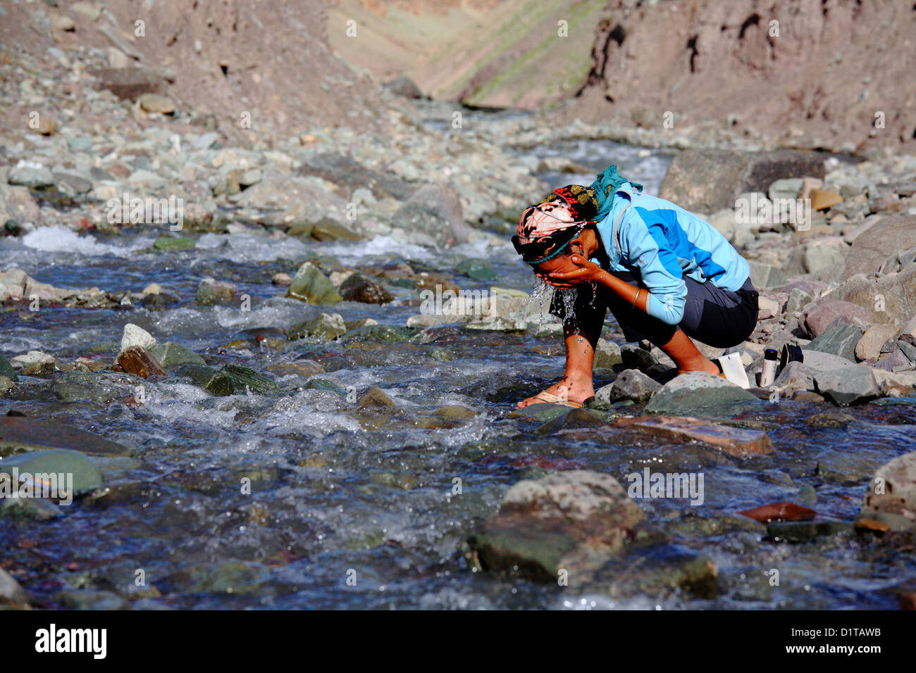 a girl washing her face in a mountain stream Stock Photo - Alamy