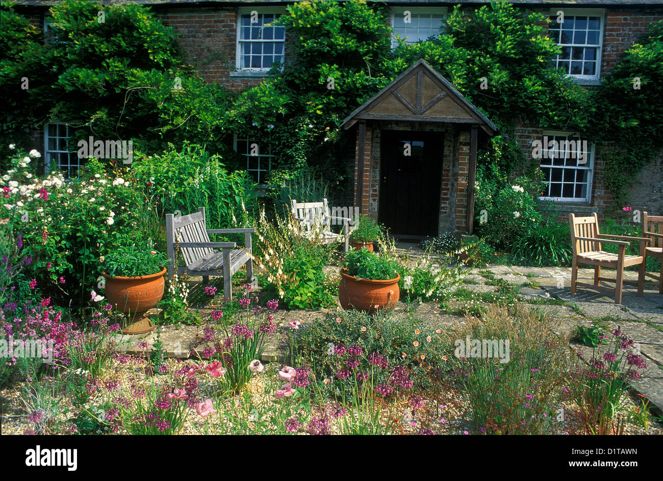 A terrace in front of a house with lots of flowers UK Stock Photo - Alamy