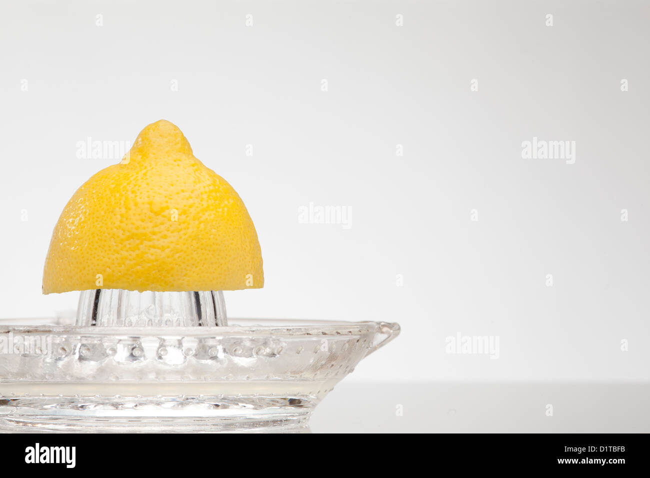 lemon press with half of lemon on white background Stock Photo - Alamy