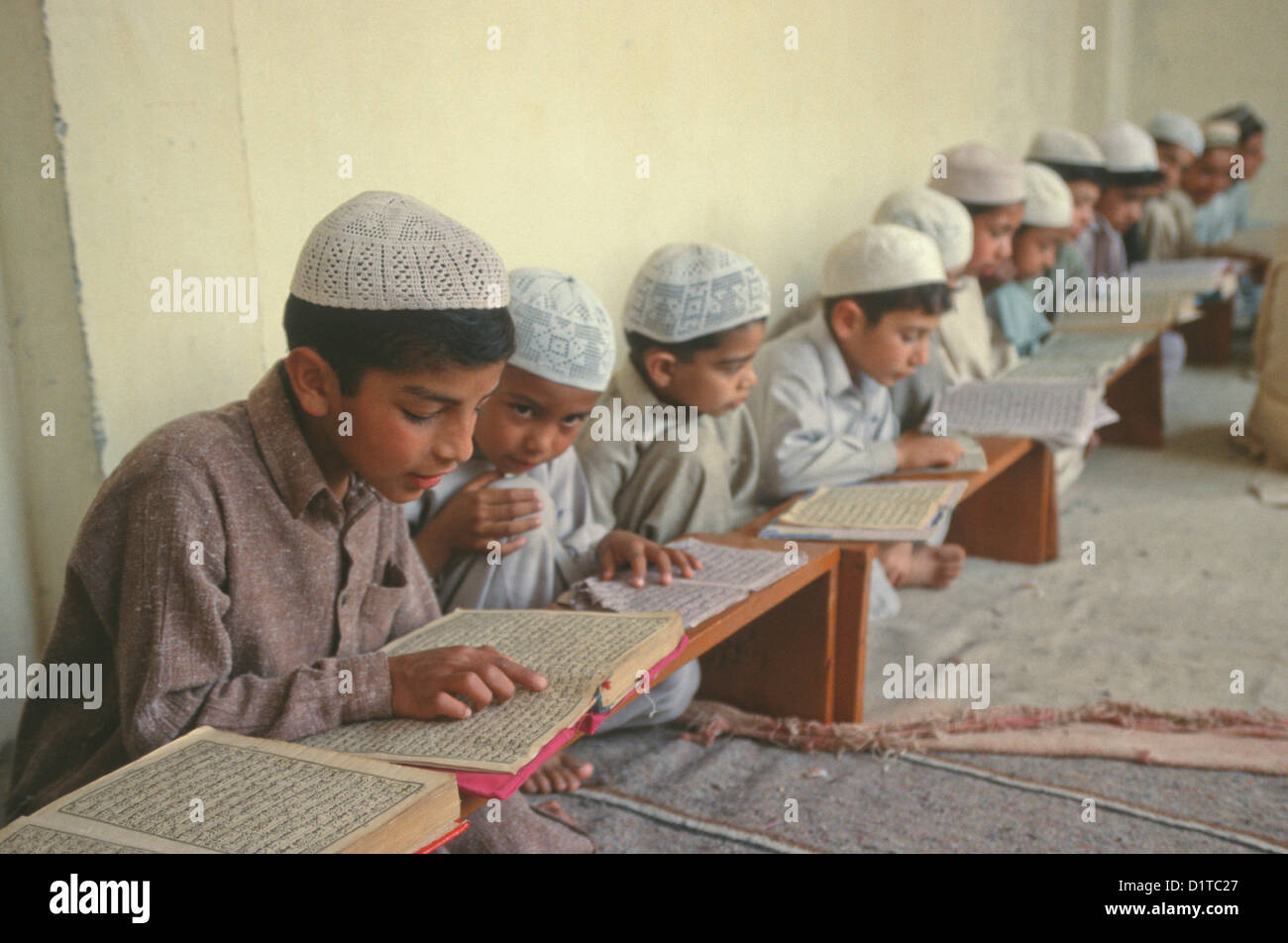 Muslim boys read the Koran in a madrassa religious school in a village ...