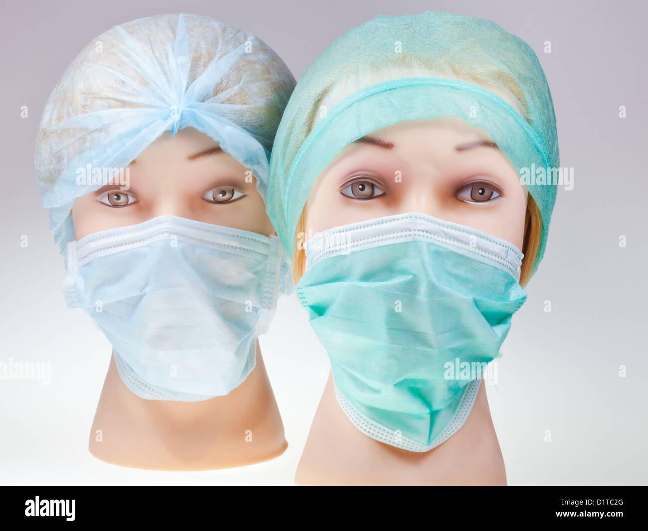 two women's dummy doctor heads wearing textile surgical cap and medical ...