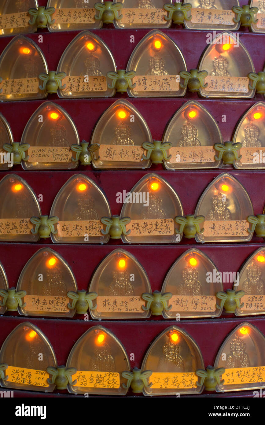 Tiny statuettes of the Buddha are stacked in a tower as good luck ...