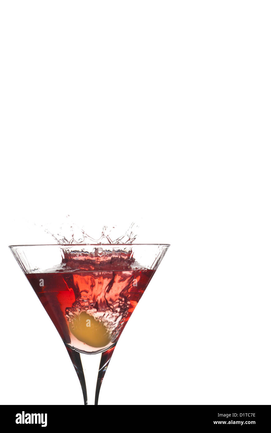 Cocktail splash like crown with olive on red martini isolated on white ...