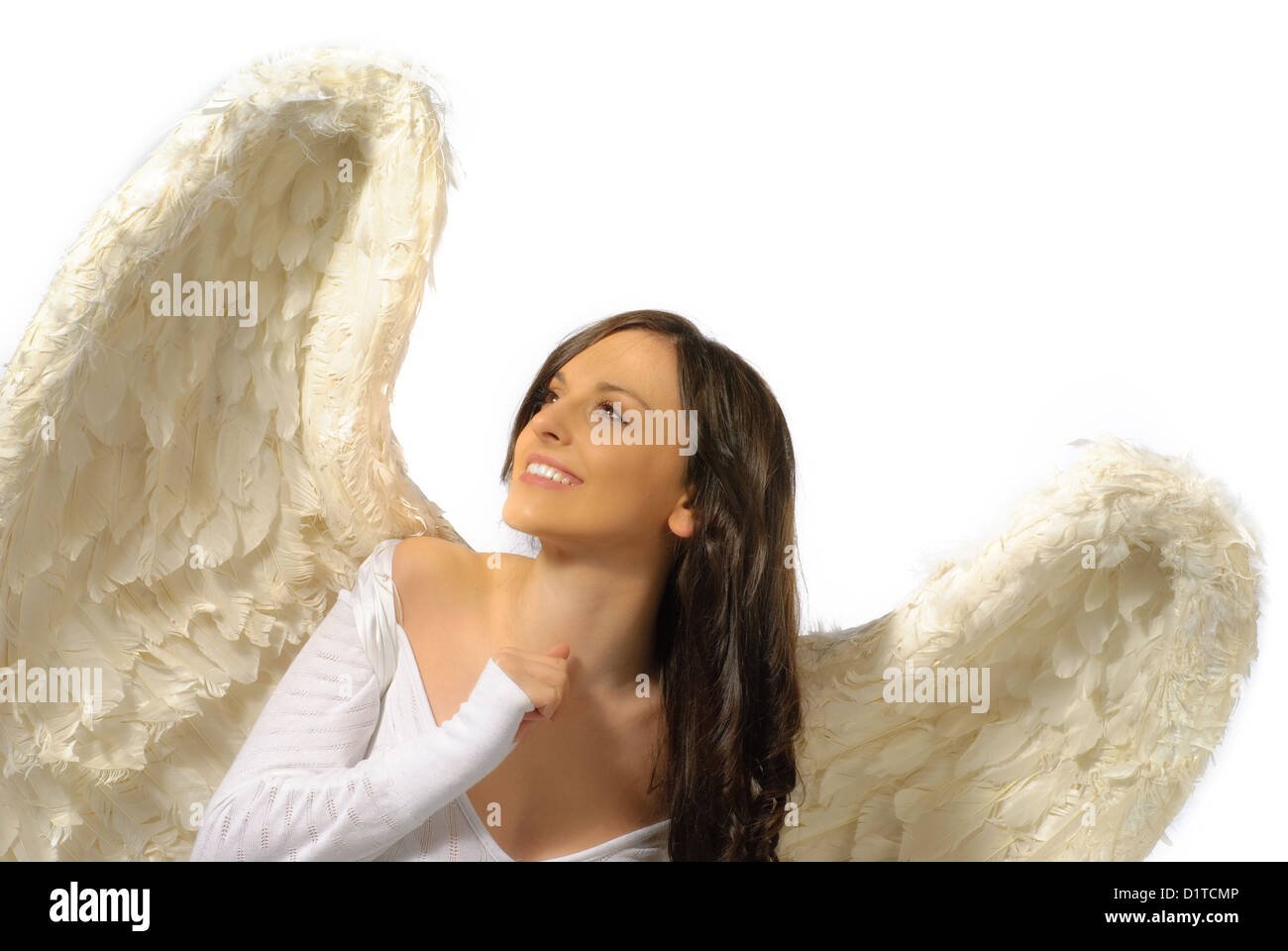 Young woman wearing angel wings with smile looking up Stock Photo - Alamy