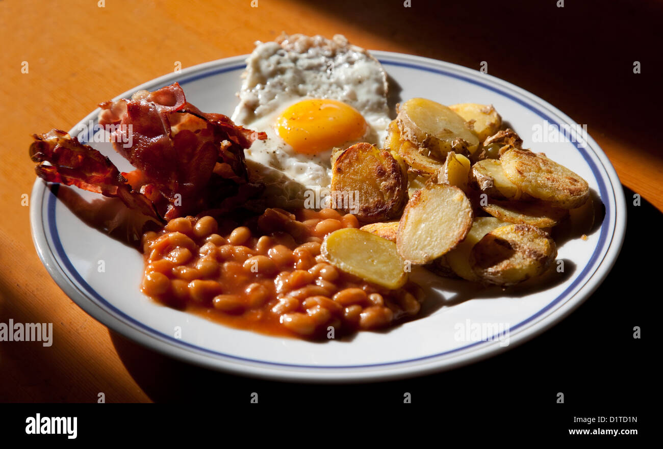 Colour photo of a English breakfast plate filled with bacon, grilled ...