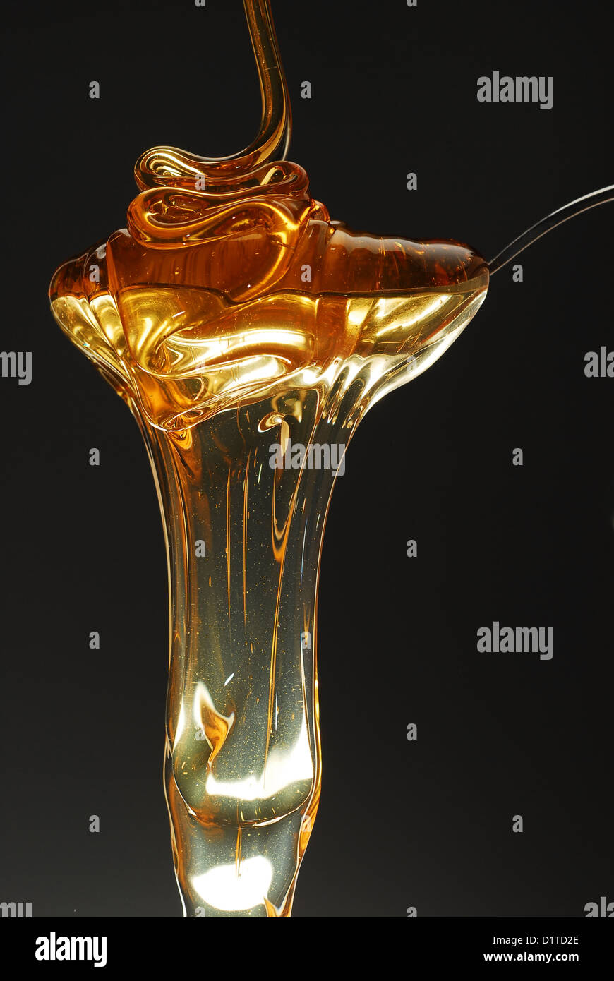 Gold honey spilling stock photo Stock Photo - Alamy