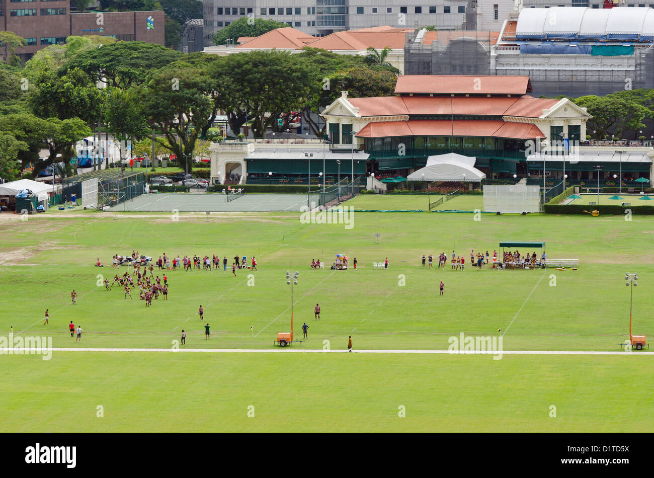 A social rugby game on the green playing field of The Padang in central ...