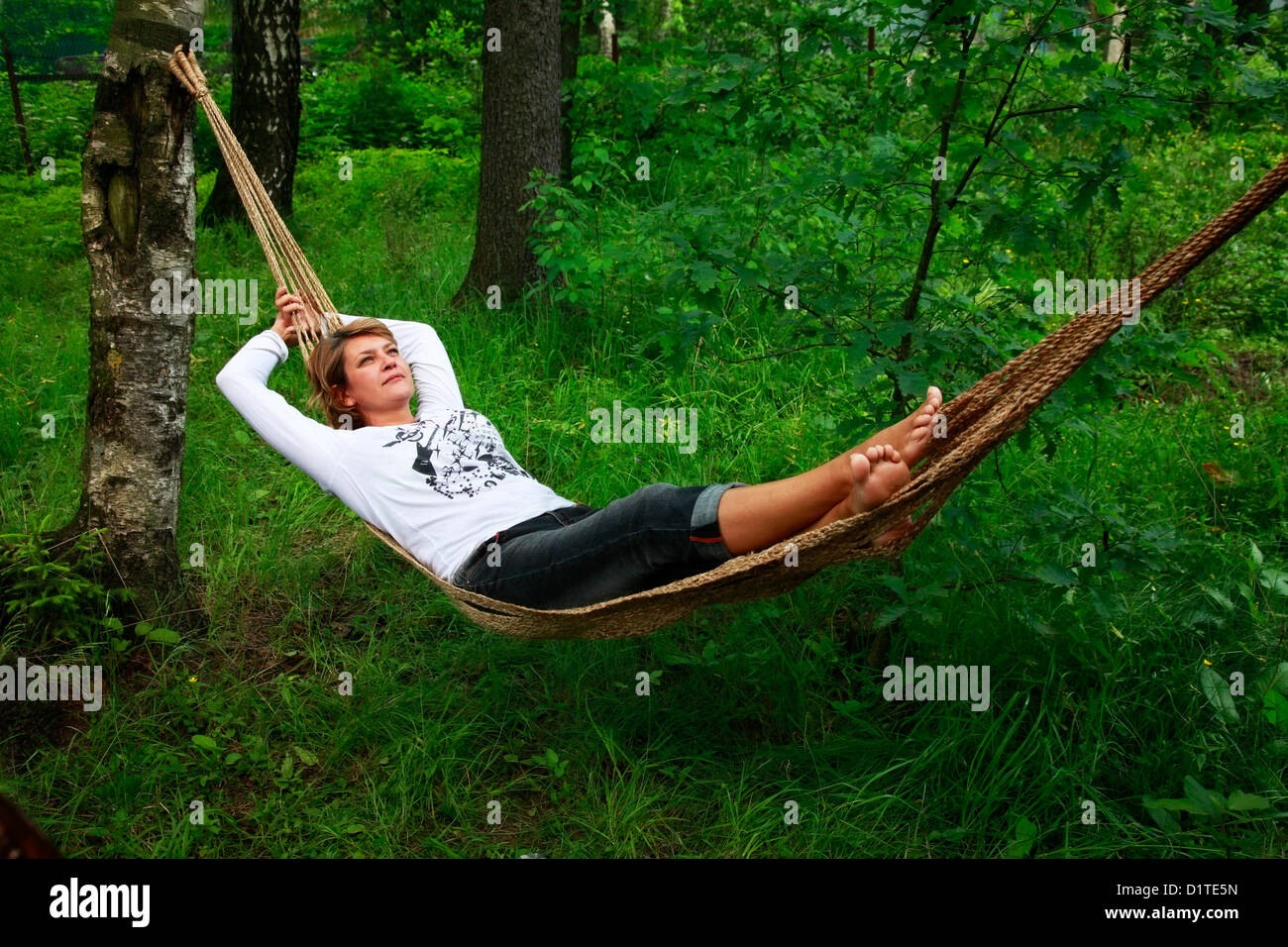 The woman enjoys laying in a hammock Stock Photo - Alamy