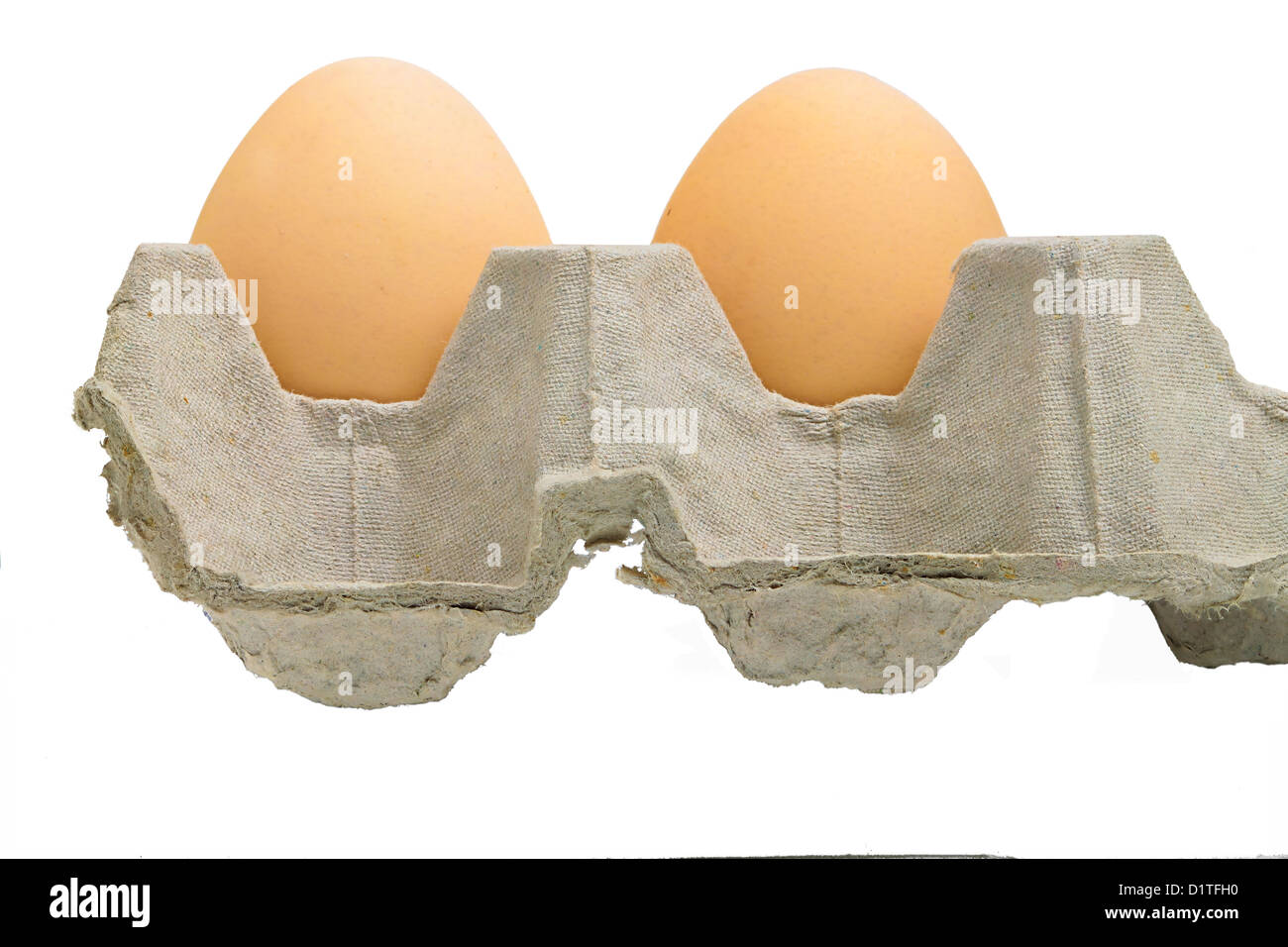 Two eggs in a tray on white isolation Stock Photo - Alamy