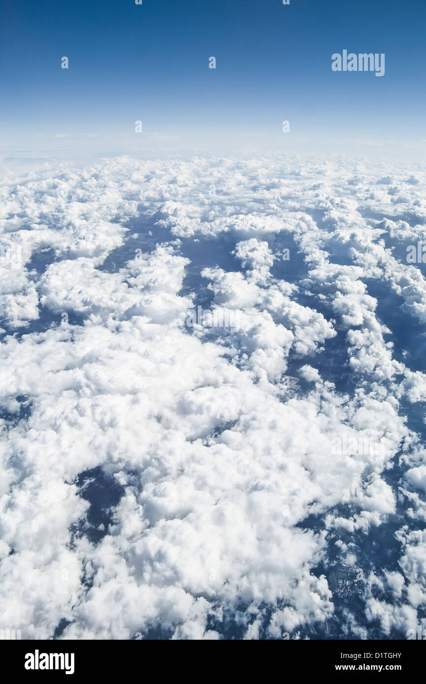 View at earth from airplane window above the clouds Stock Photo - Alamy