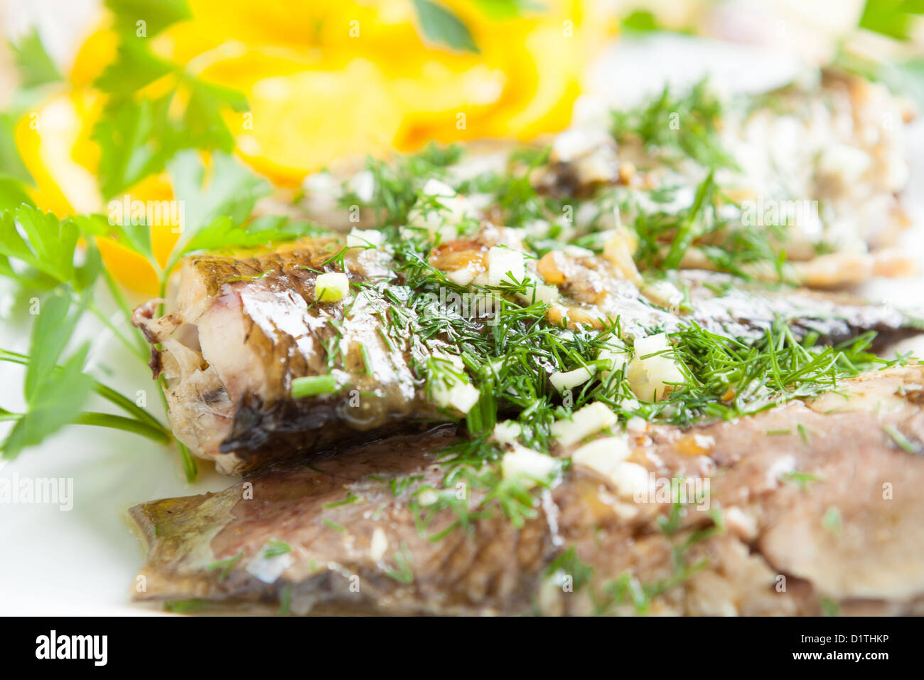 Roast Fish with garlic sauce, closeup Stock Photo - Alamy