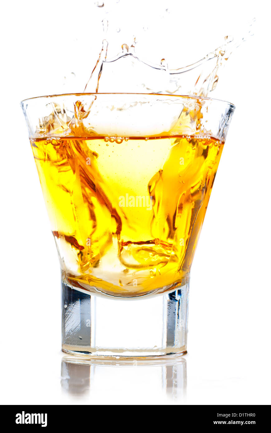 Splash of whiskey on the rocks Stock Photo - Alamy