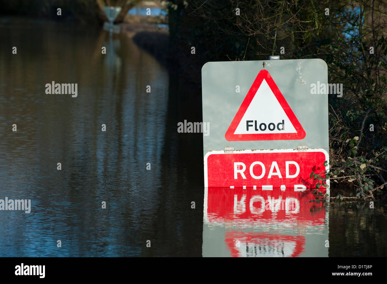 Flooded road and warning sign Stock Photo - Alamy