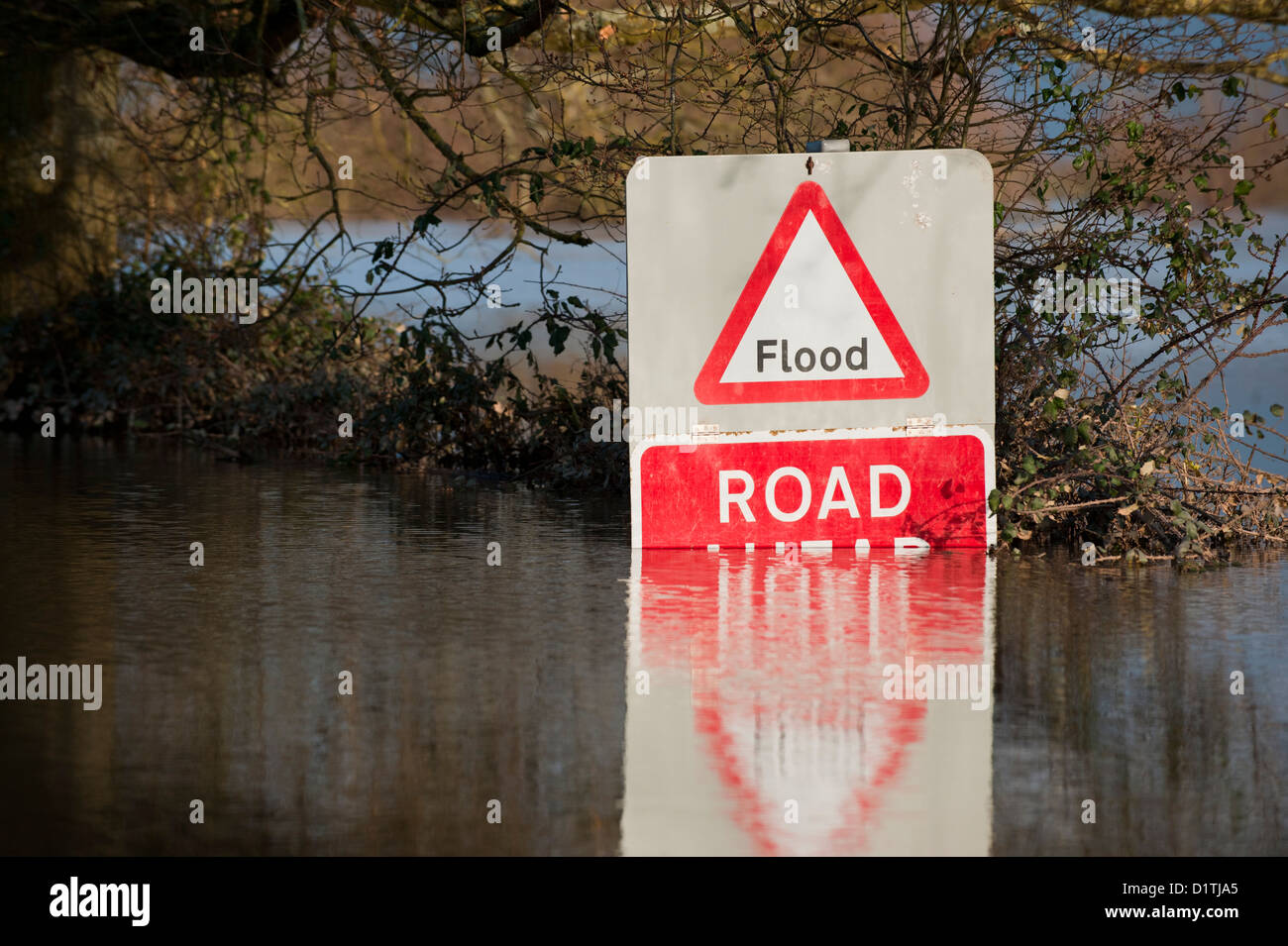 Flooded road and warning sign Stock Photo - Alamy
