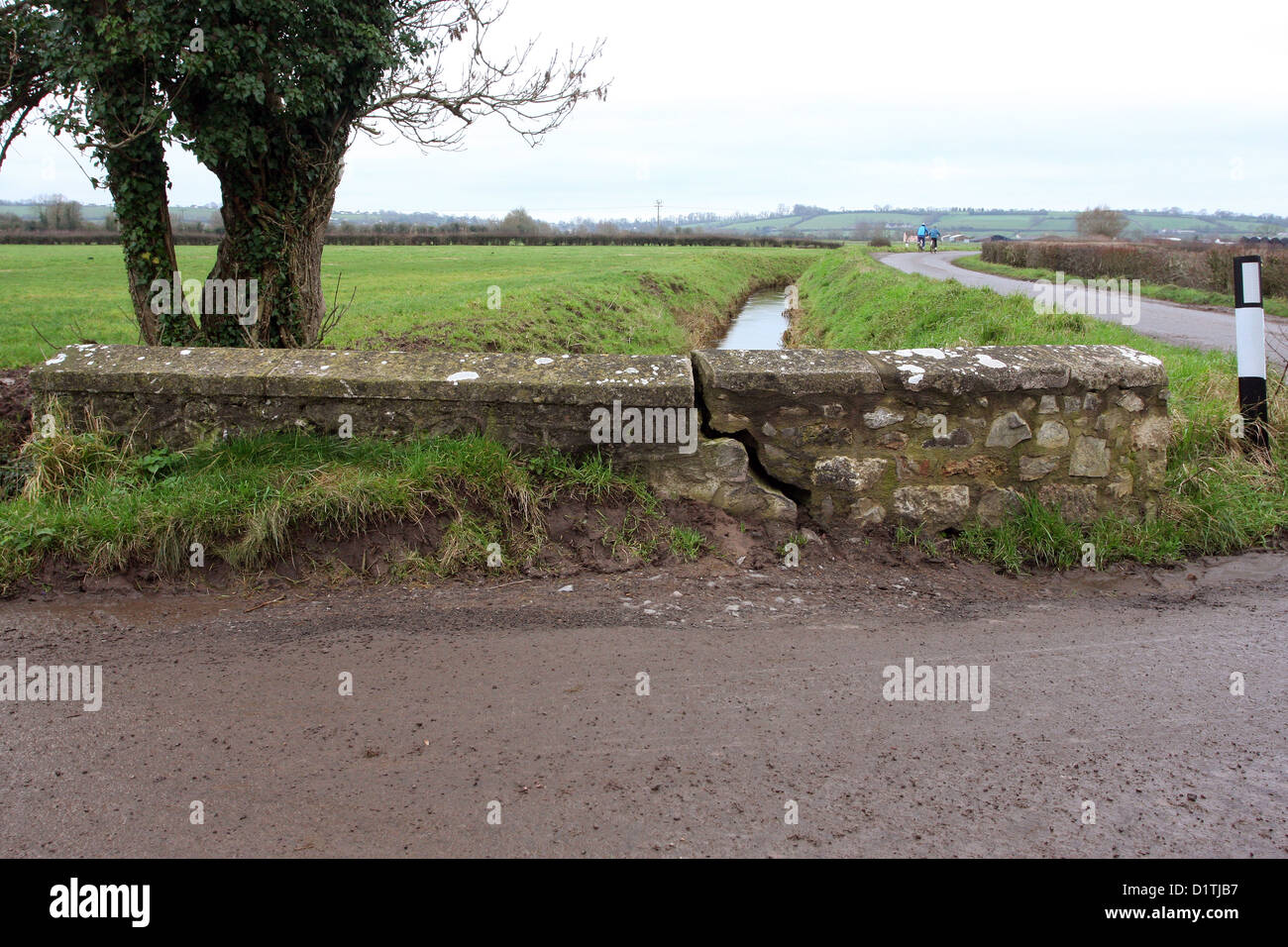 Very old and cracked bridge over a drainage ditch, known as a rhyne on ...
