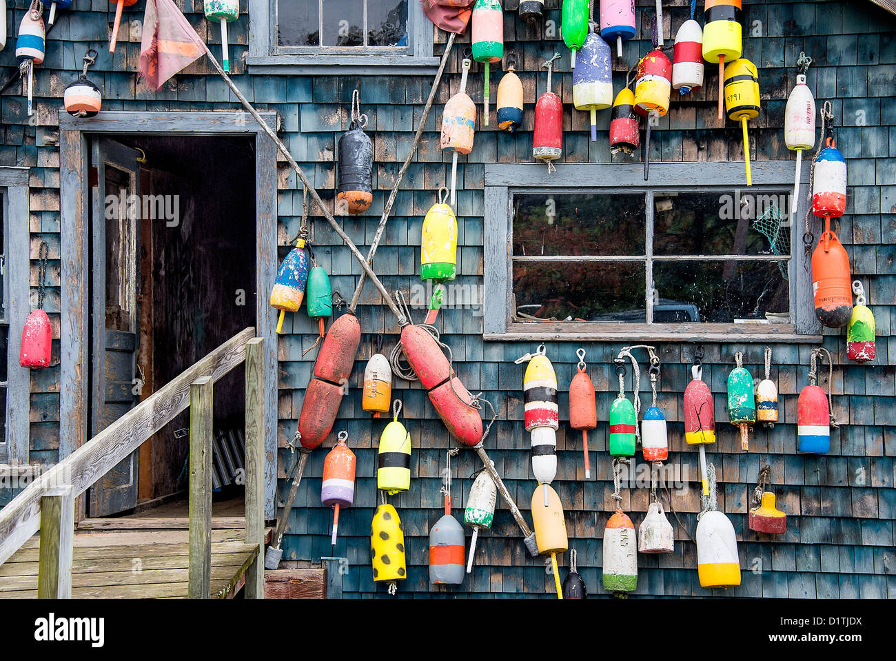 Colorful buoys adorn a rustic coastal shack, Bernard, Mt Desert Island ...