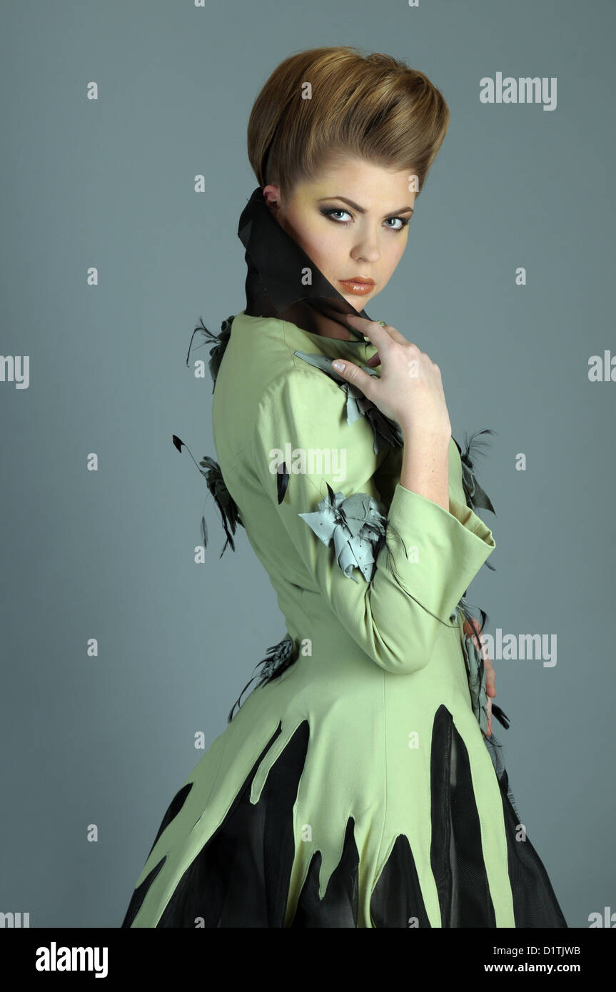 Portrait of beautiful female model on light blue background Stock Photo ...