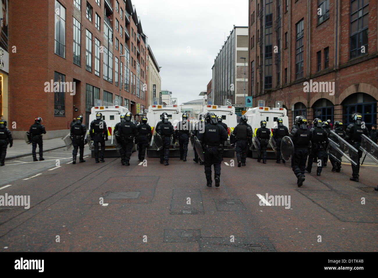 Belfast, UK. 5th Jan, 2013. PSNI officers in Riot gear follow Loyalist ...