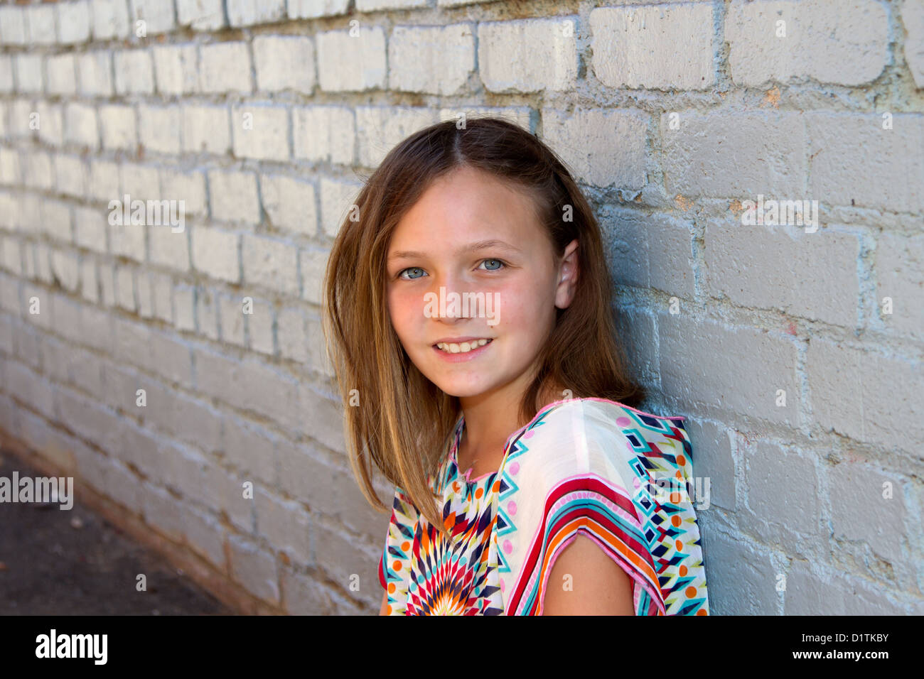 A young pre teen Caucasian girl modeling 1960s style tie dyed clothes ...