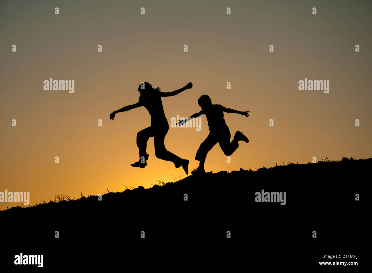 children running silhouette sunset in the form of Stock Photo - Alamy