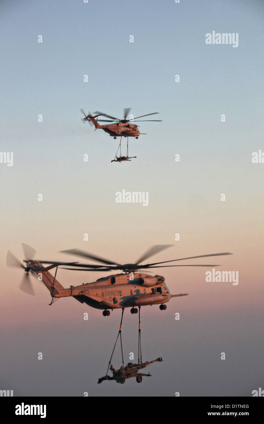 Two US Marine Corps CH-53E Super Stallion helicopters transport M777 ...