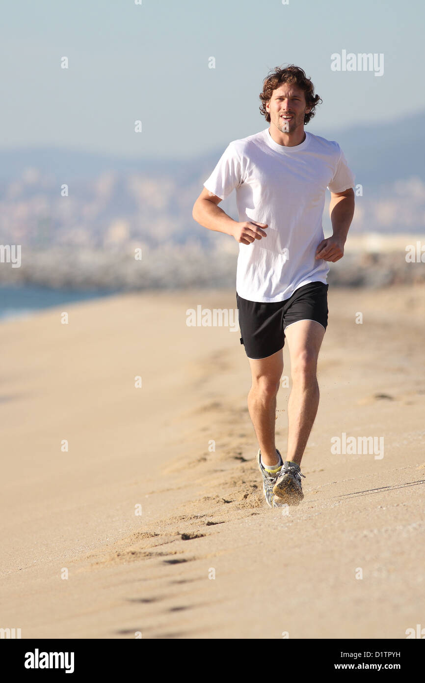 Man running in the beach. Front view Stock Photo - Alamy