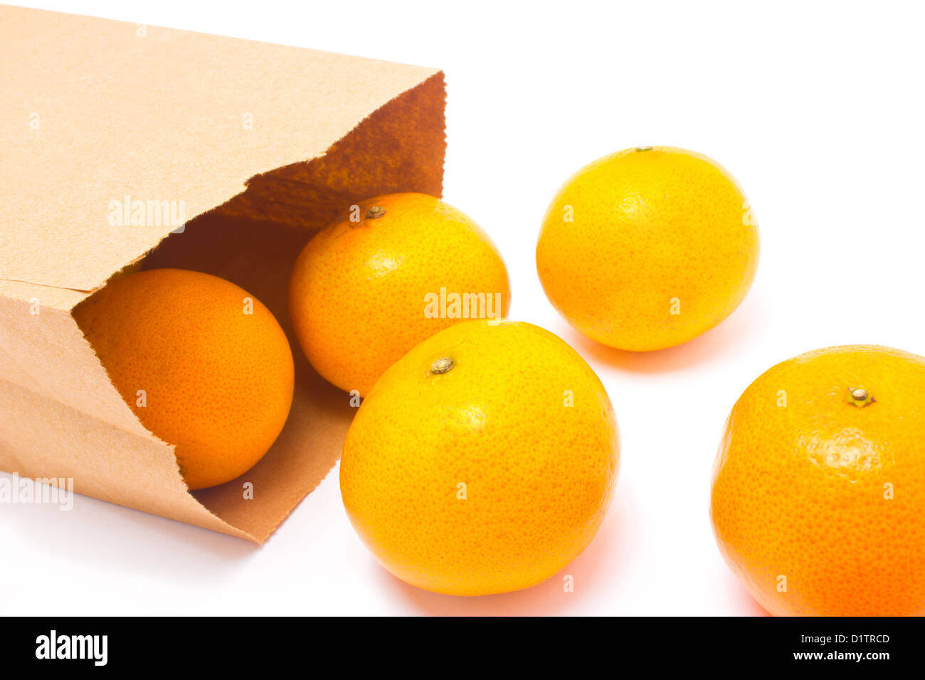 Oranges falling from paper bag, isolated on white background Stock ...